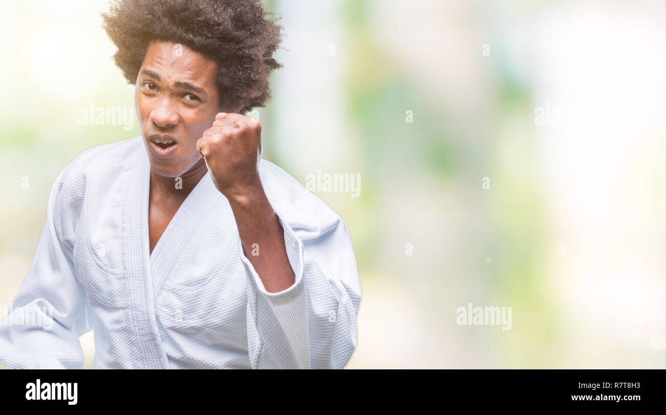 Afro american man wearing karate kimono over isolated background angry ...