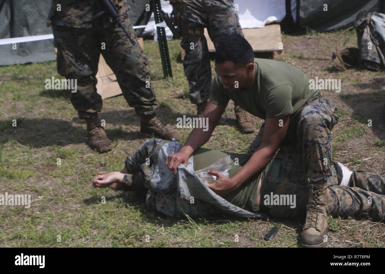 Marines perform first aid skills they learned in a combat life-savers ...