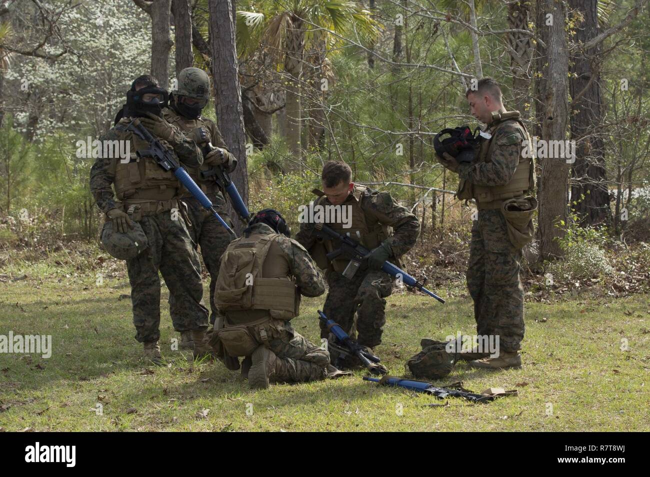 Marines check their gear before practicing room-clearing techniques ...