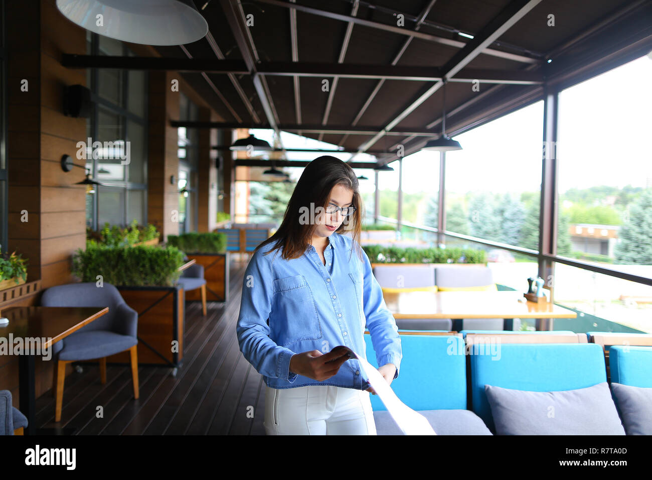 Pretty woman reading menu at restaurant with close up face Stock Photo ...