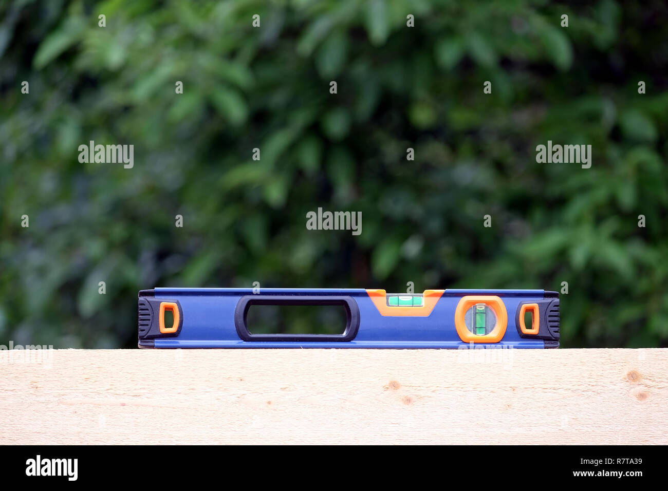 The building horizontal bubble level sits on a wooden beam, shows the ...
