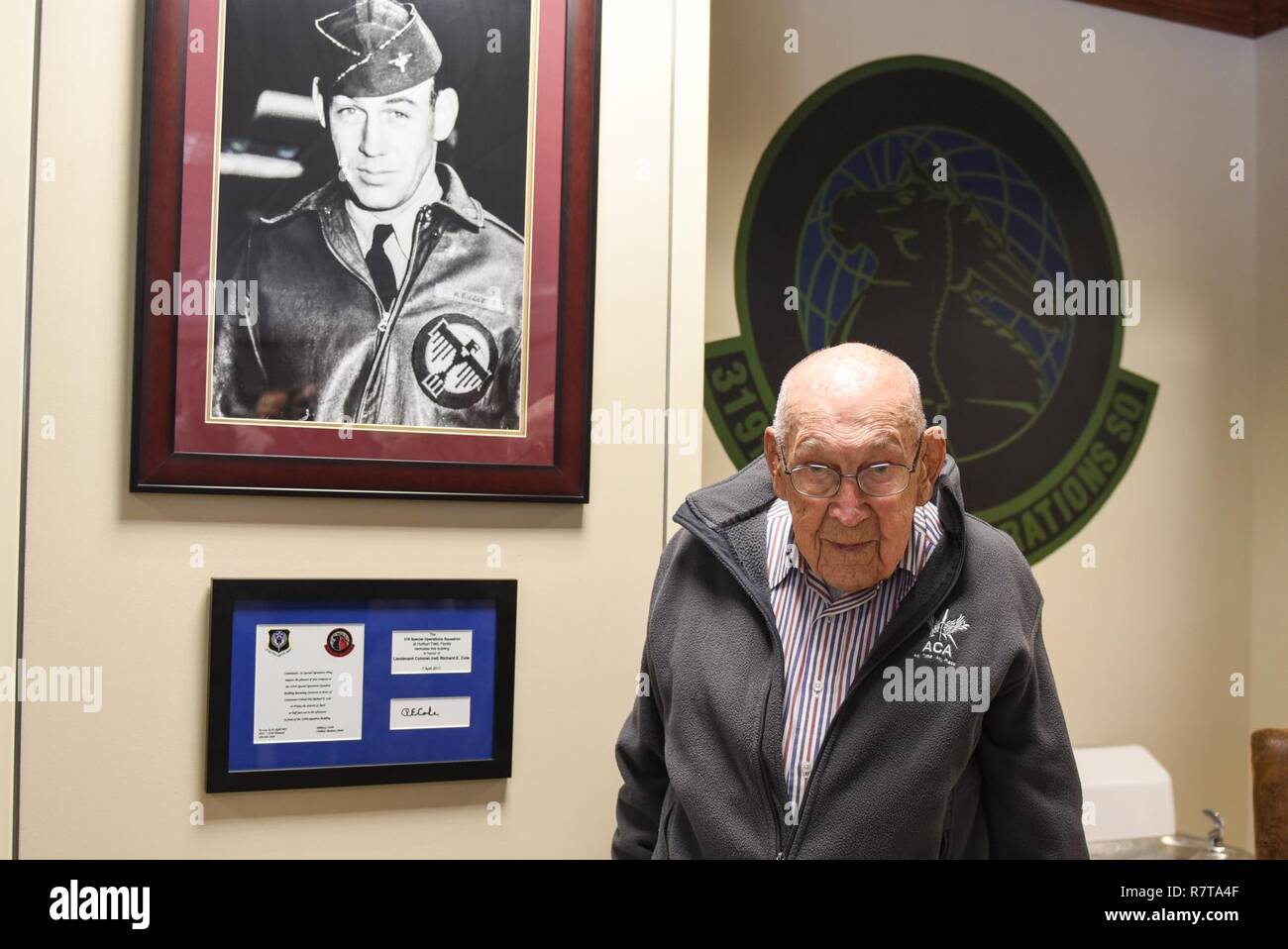 Retired Lt. Col. Richard E. Cole stands with a portrait of himself from ...
