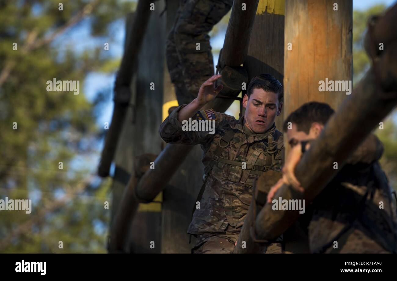 U.S. Army Rangers climb an obstacle during the Best Ranger Competition ...
