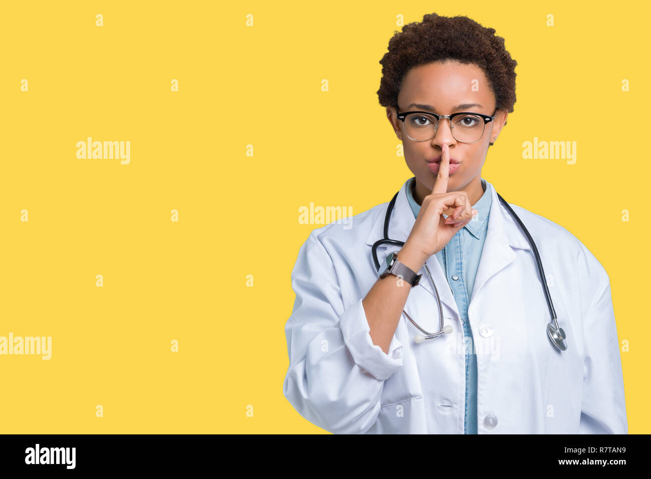 Young african american doctor woman wearing medical coat over isolated ...