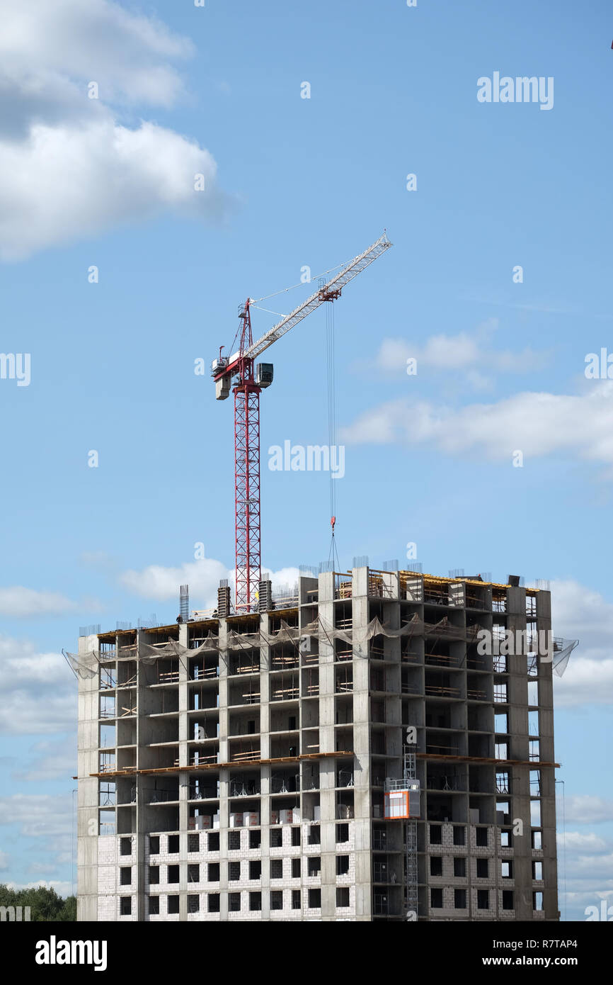 Big hoisting tower crane and top section of modern construction ...