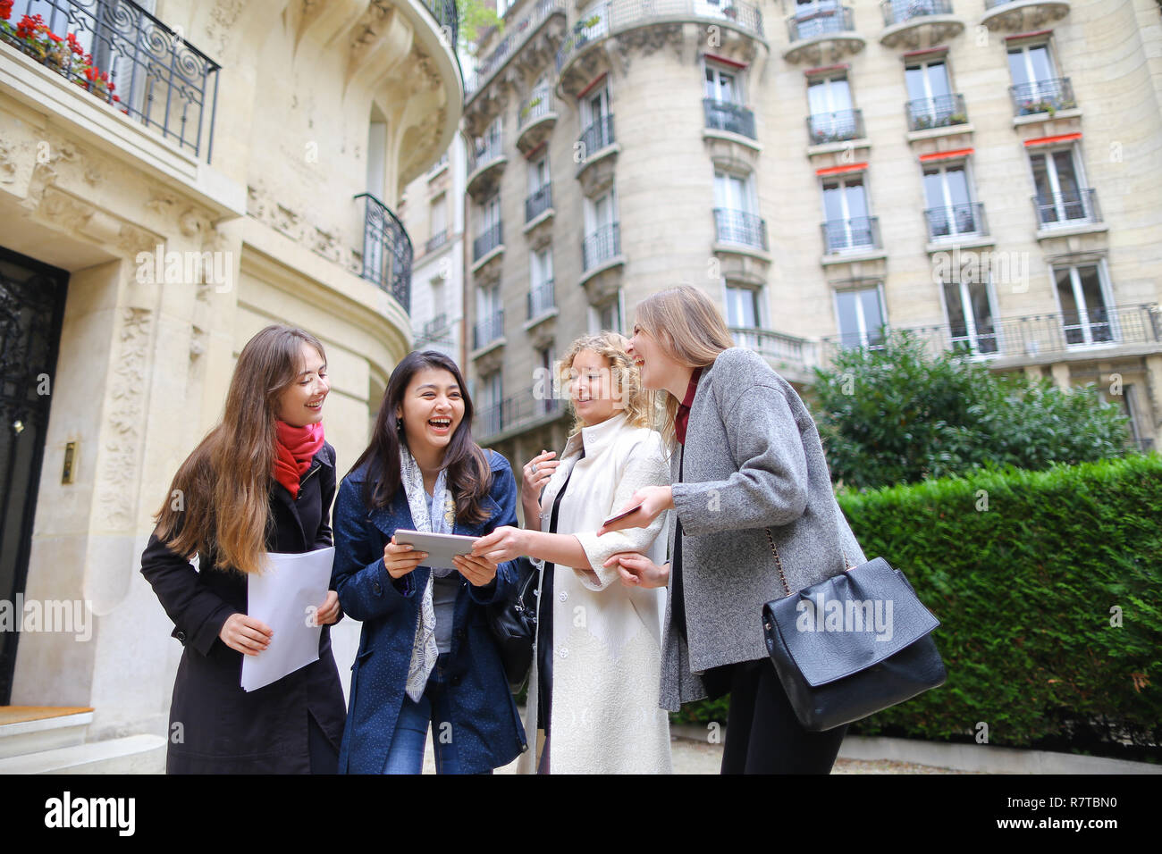 Professor talking with new students near university building in Stock ...