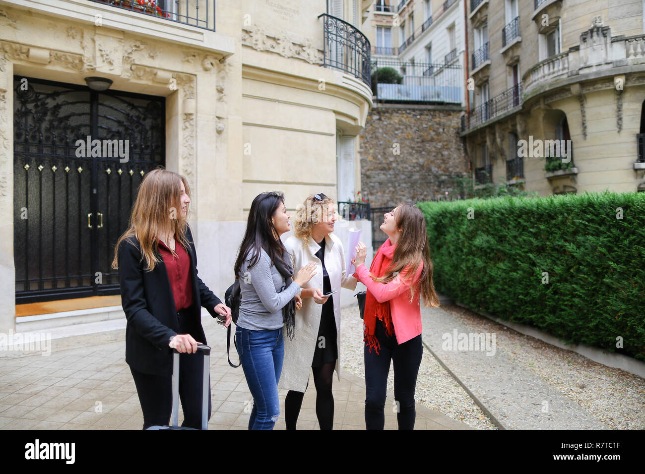 Happy students leaving university building in Stock Photo - Alamy
