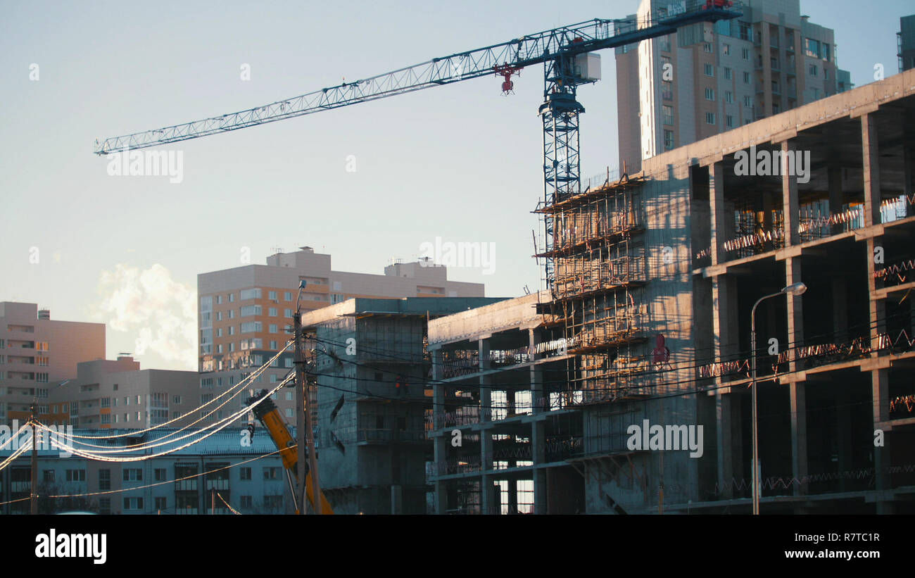 Construction site. Working tower cranes and concrete building frames ...