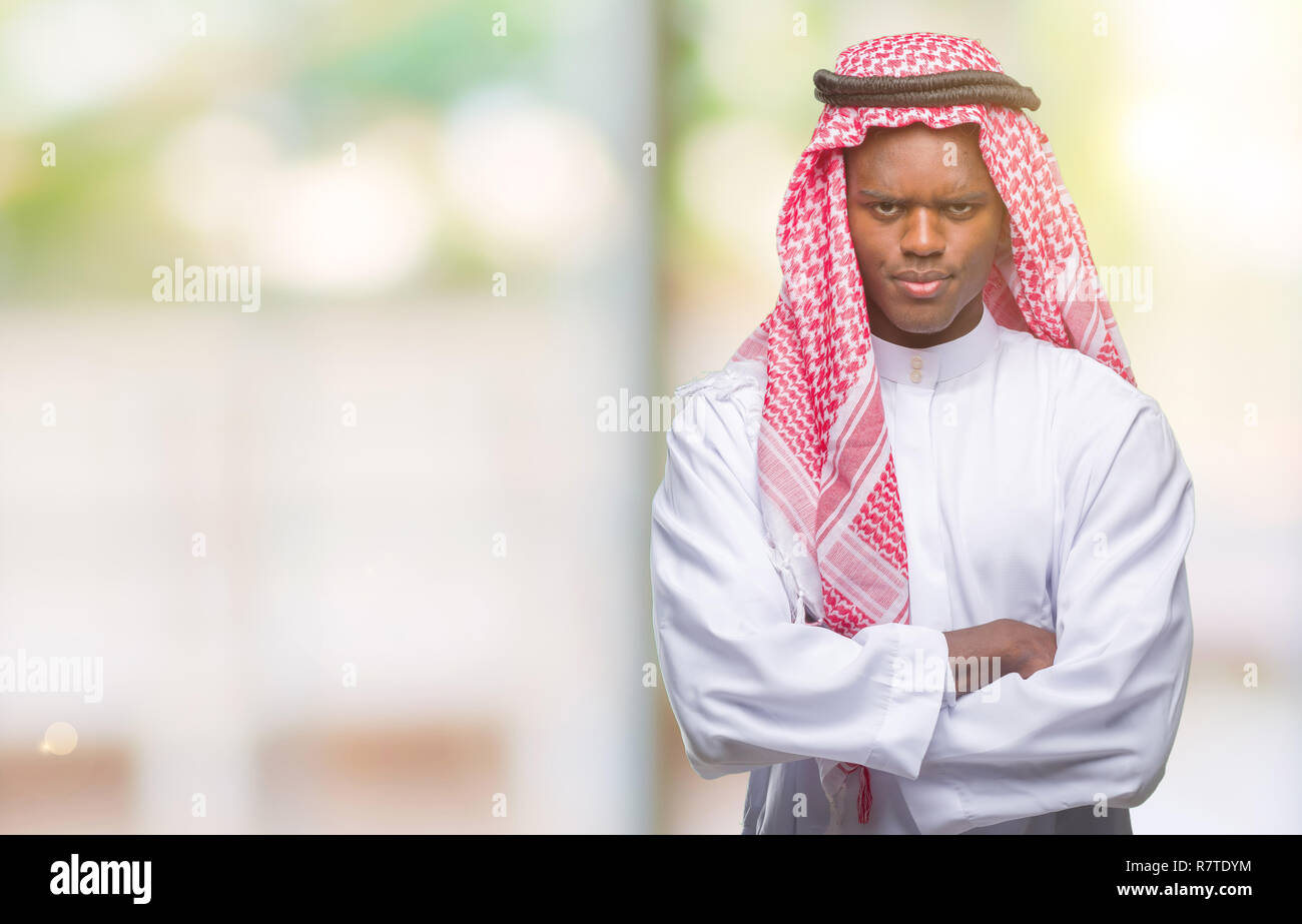 Young arabic african man wearing traditional keffiyeh over isolated ...