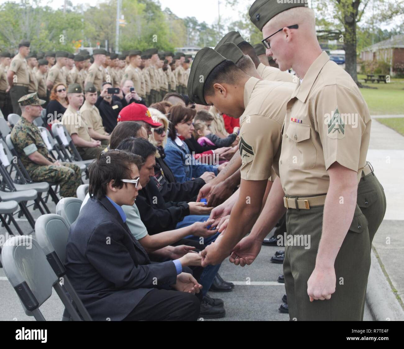 Marines hand ceremonial purple heart pins to family of fallen Marines ...