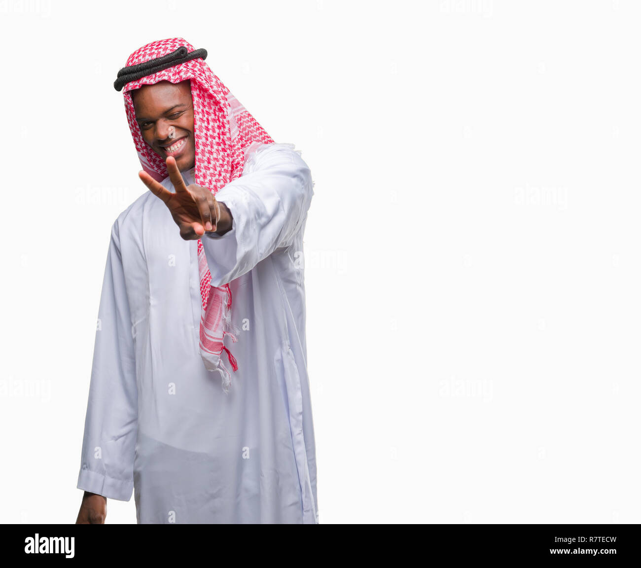 Young arabic african man wearing traditional keffiyeh over isolated ...