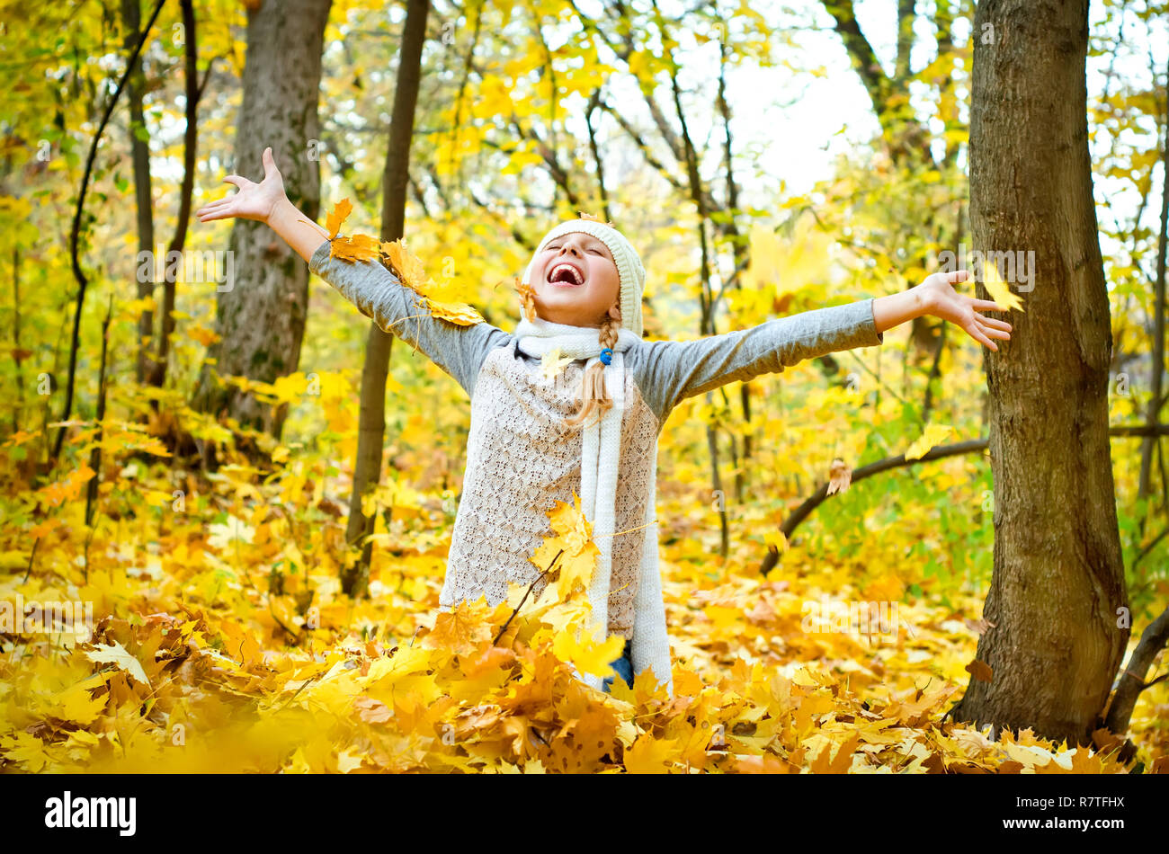 little girl throwing autumn leaves Stock Photo - Alamy