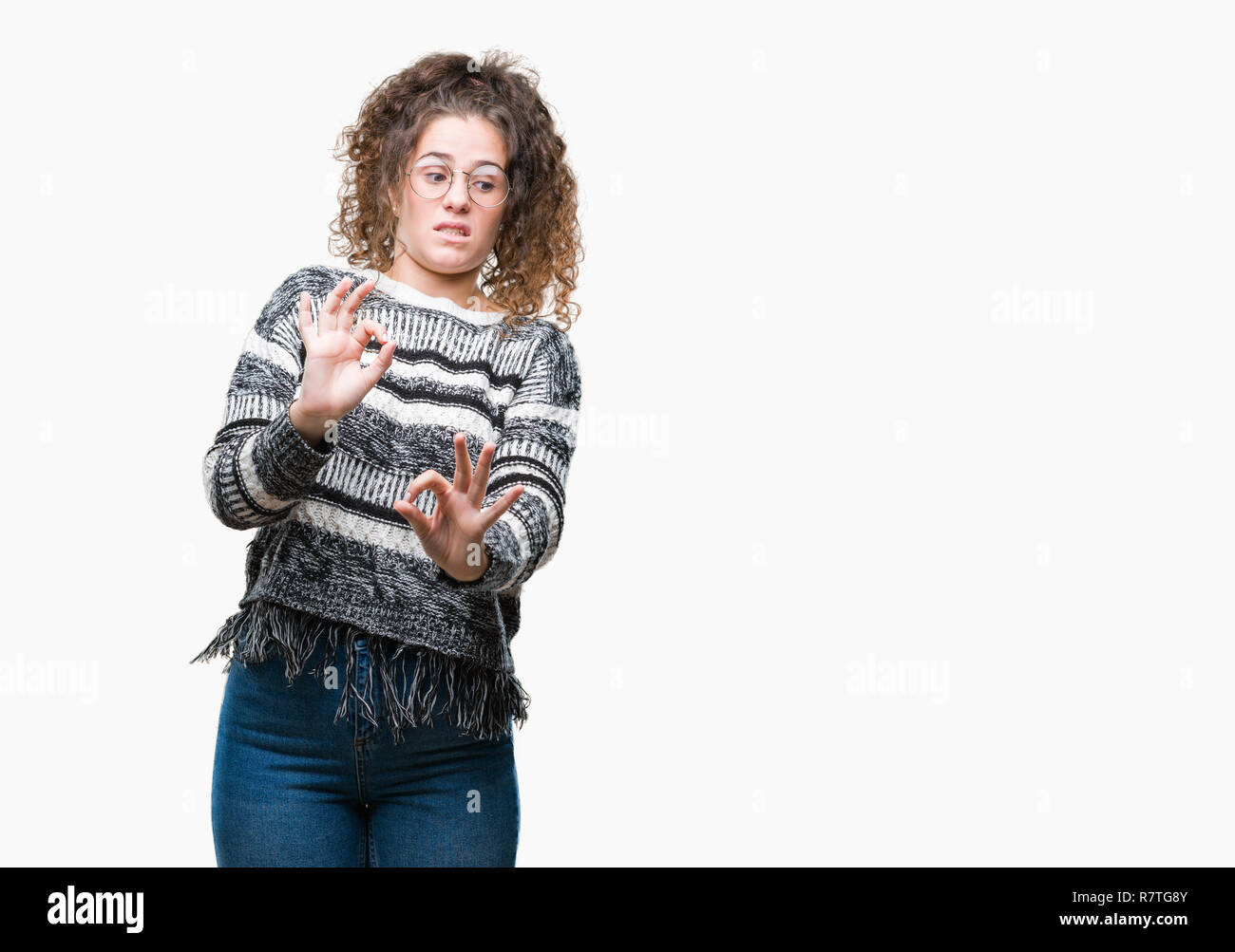 Beautiful brunette curly hair young girl wearing glasses over isolated ...