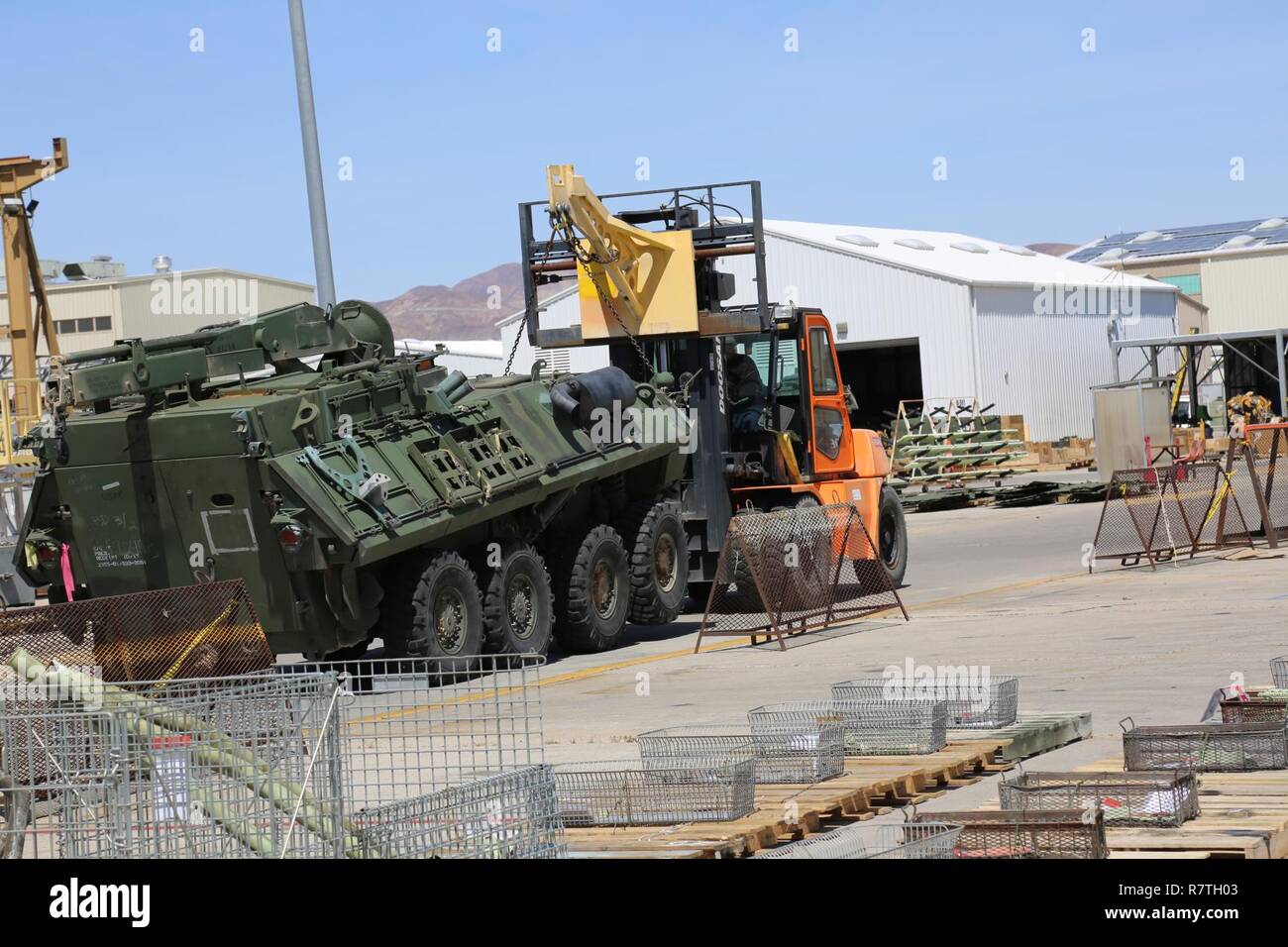 Eddie Batista, tractor operator, tows a Light Armored Vehicle to an ...
