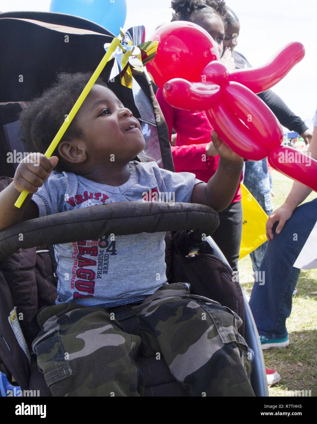 Mason, a 2-year-old military child, admires a balloon ninja made during ...
