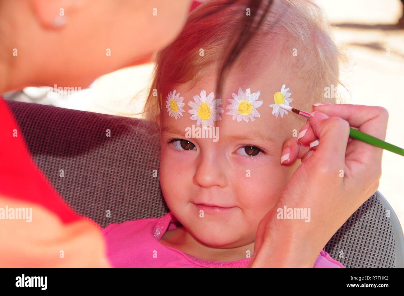Ani Hugo, 3, gets her face painted during the 924th Fighter Group’s ...