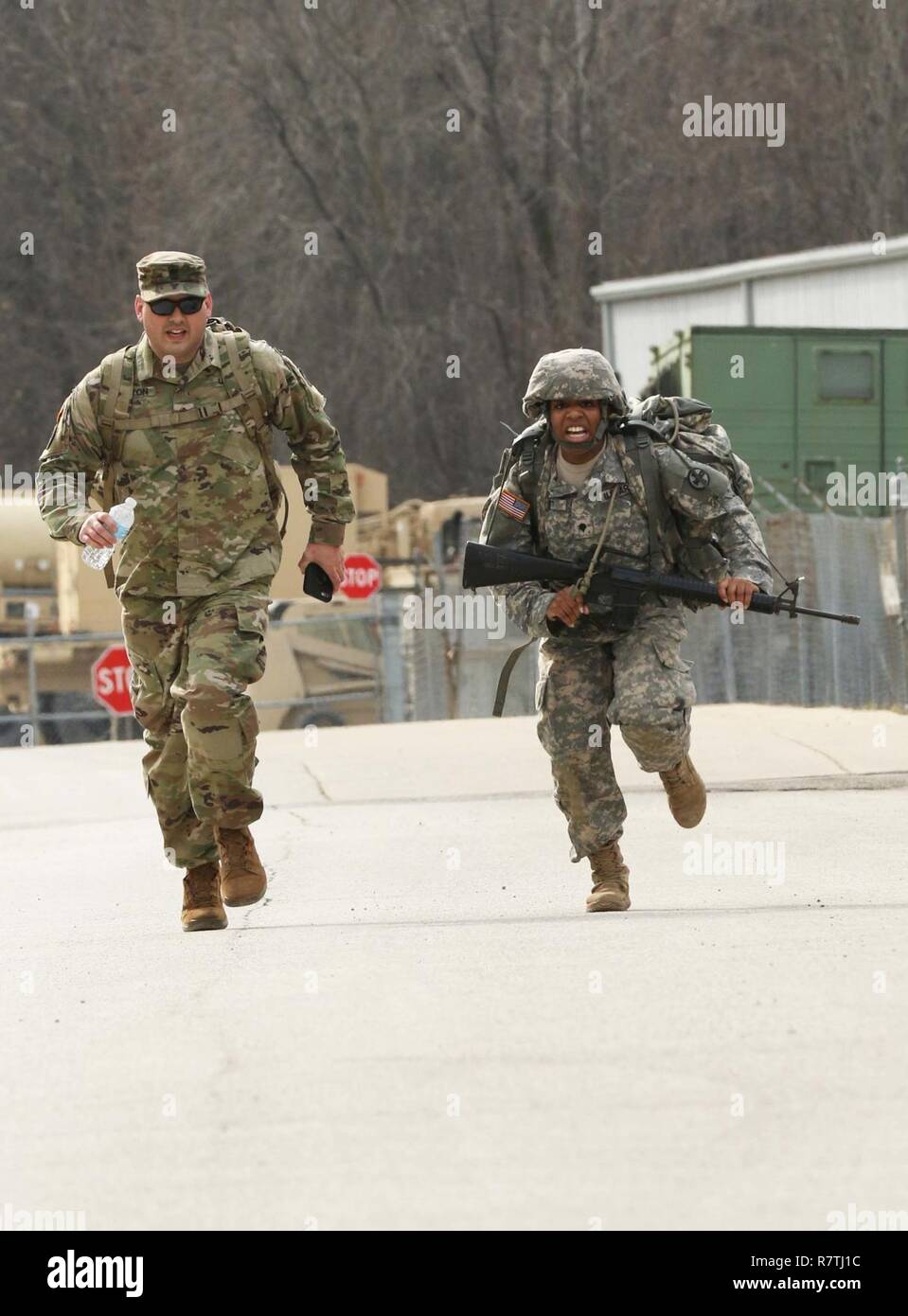Spc. Myeeah Scott (right) sprints across the finish line of an eight ...