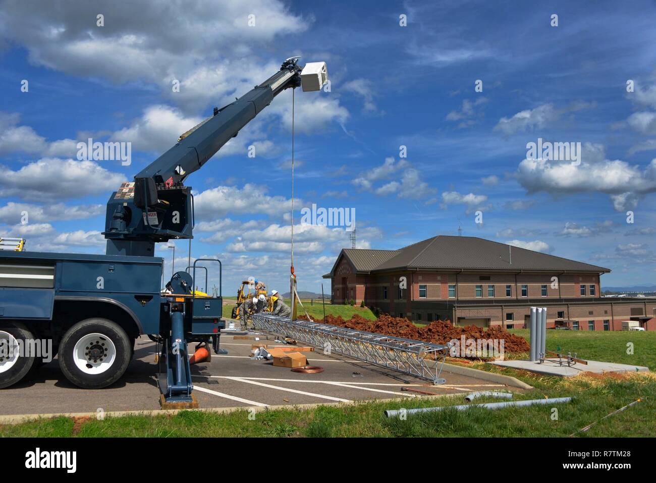 Members of the 241st Engineer Installation Squadron construct and erect ...