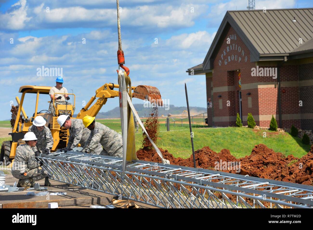 Members of the 241st Engineer Installation Squadron help to erect a ...