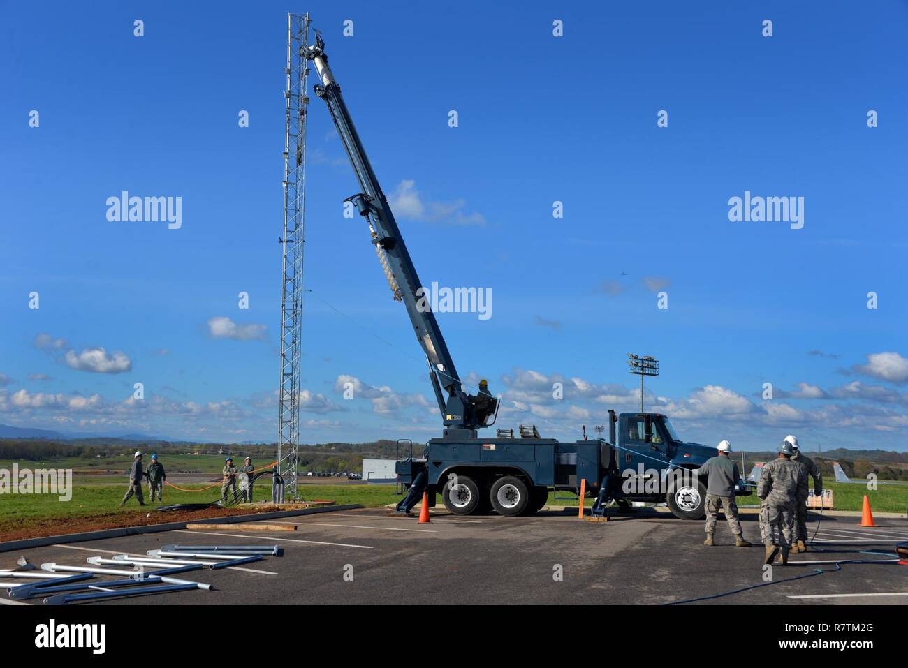 Members of the 241st Engineer Installation Squadron help to erect a ...