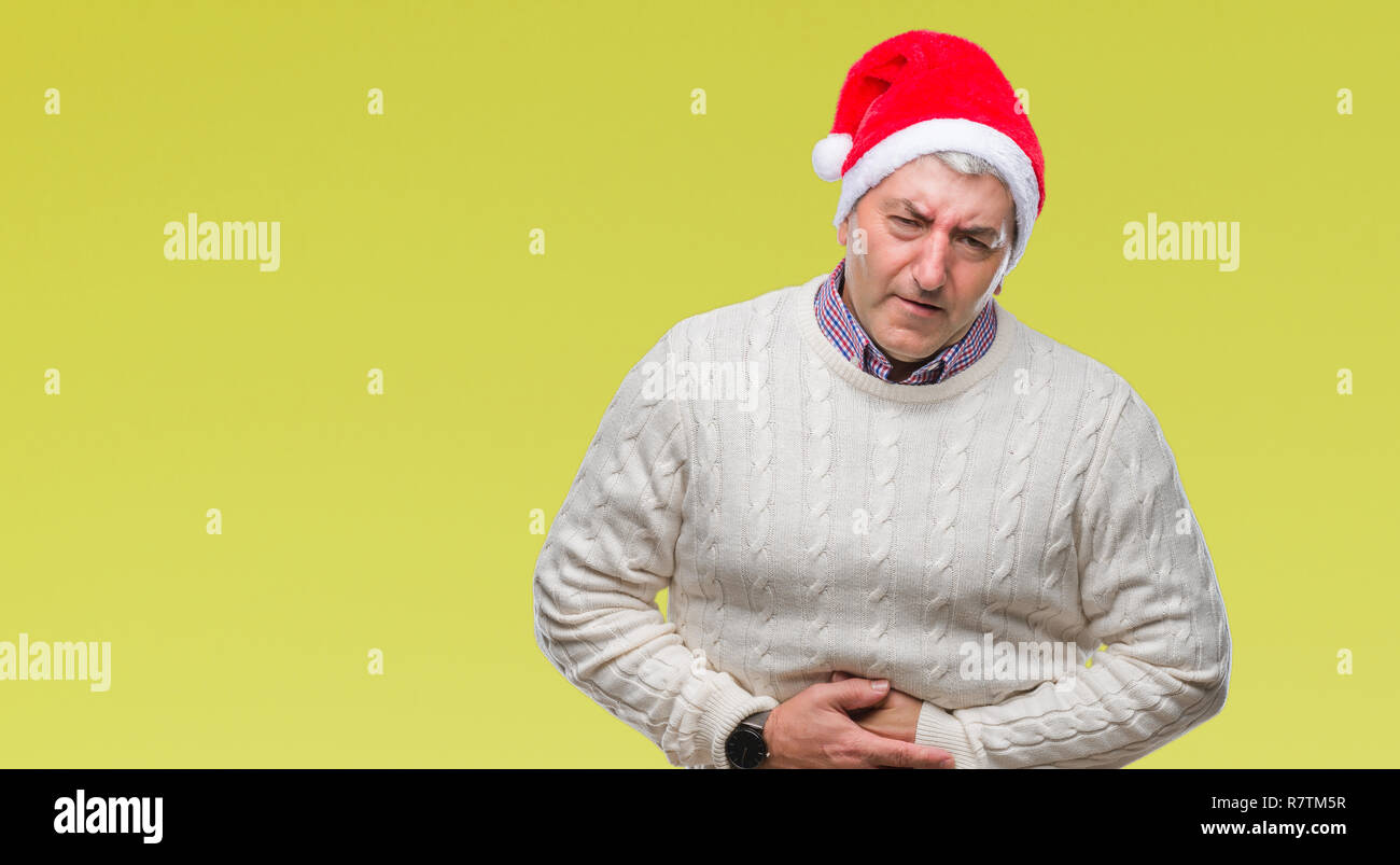 Handsome senior man wearing christmas hat over isolated background with ...