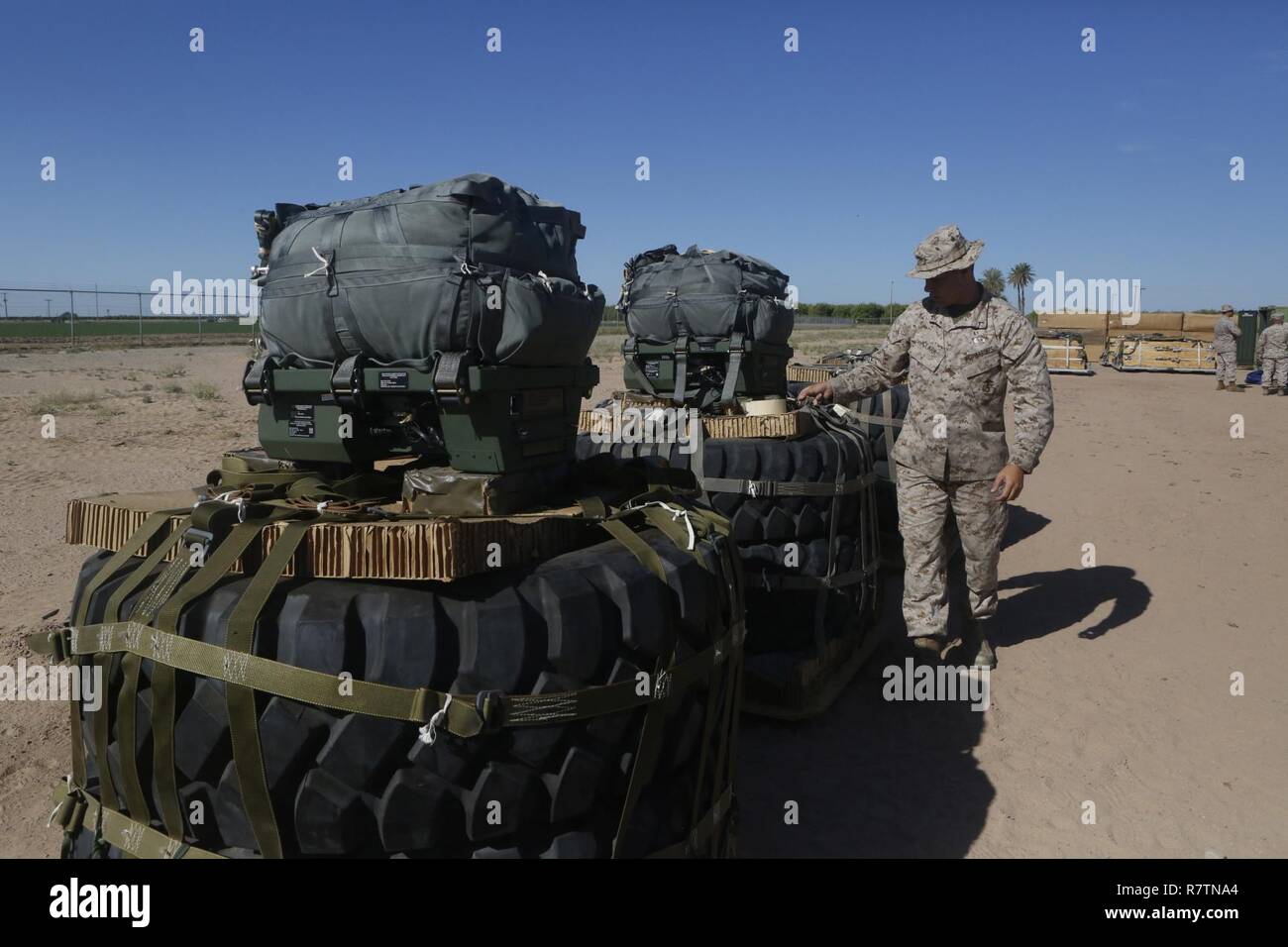 U.S Marine Pfc. Brad A. Clark inspects the rigged aerial delivery ...