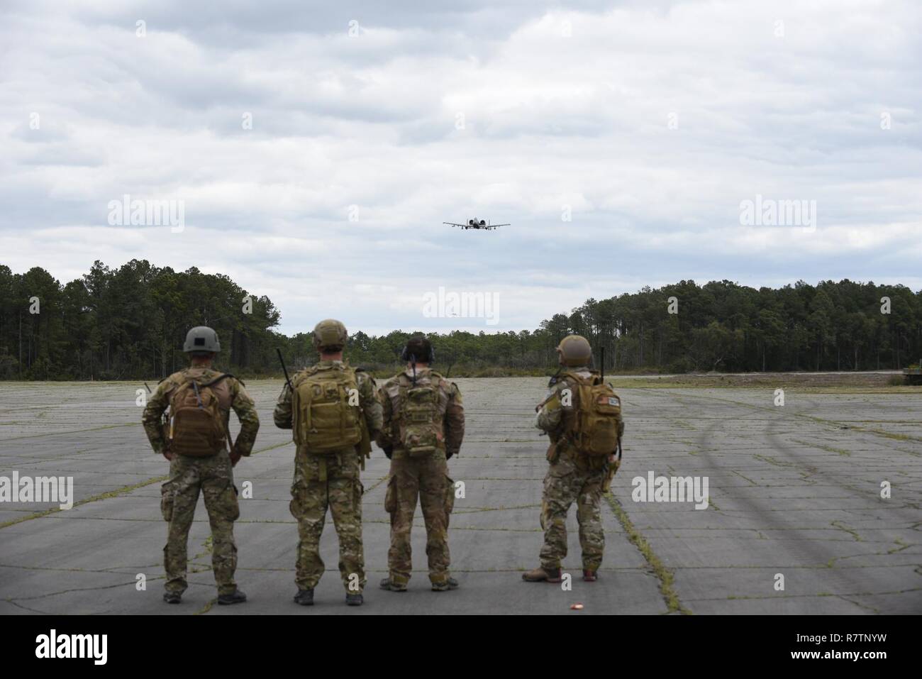 An A-10C Thunderbolt II flies over a group of tactical air control ...