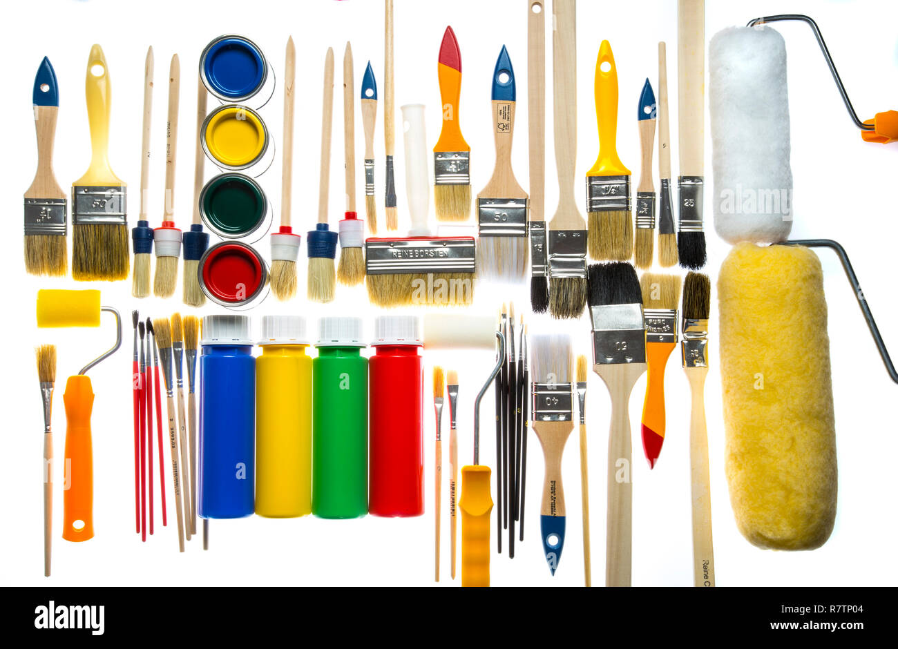 Different sized brushes, paint rollers, cans of paint and bottles of ...