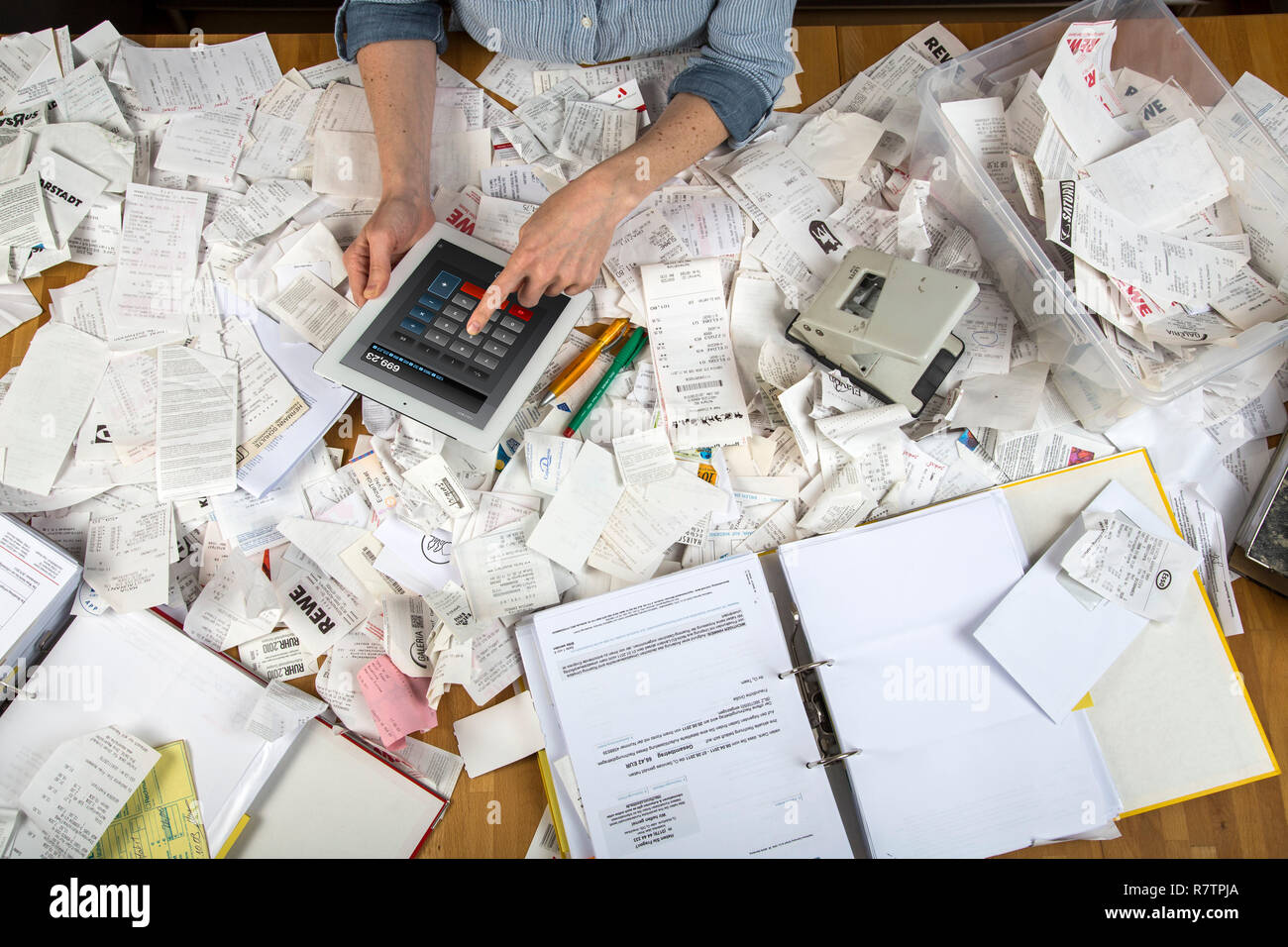 Woman with invoices and receipts on a desk, for the tax return ...