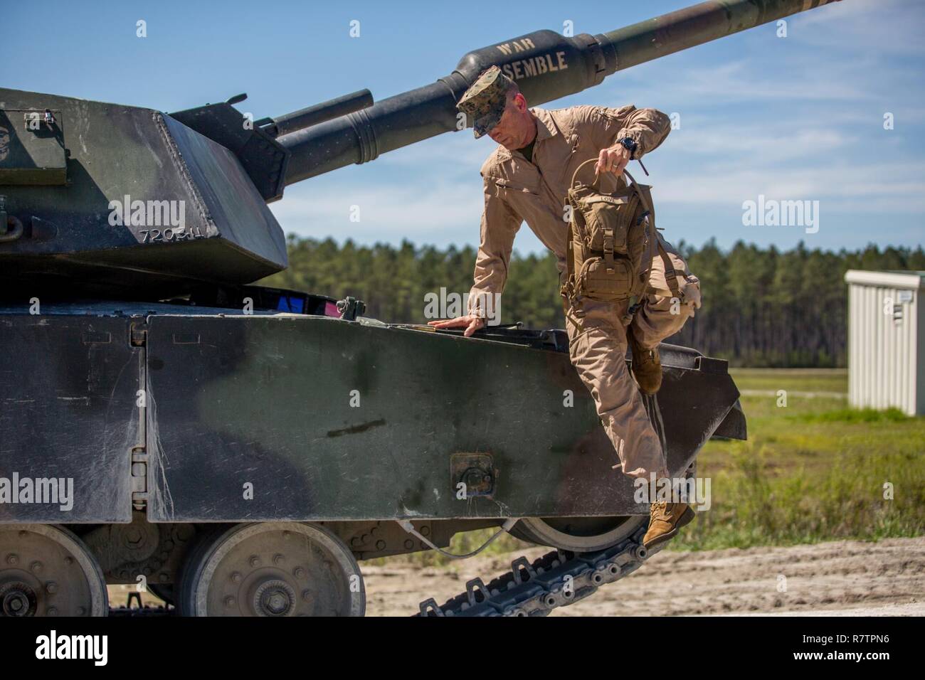 Major Gen. John K. Love jumps down from an M1A1 Abrams Tank at Camp ...