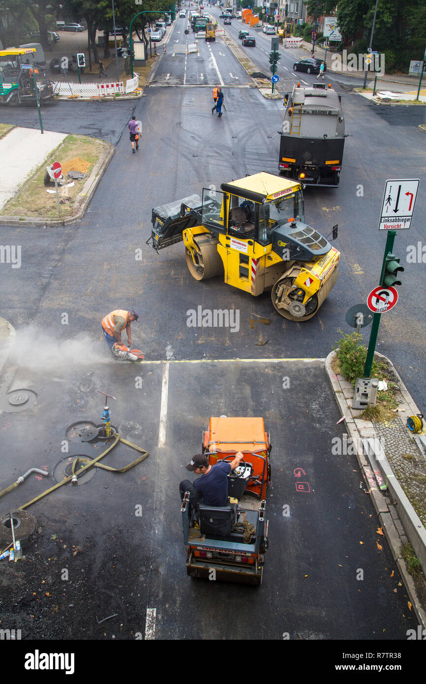 Roller compactors, tarmac laying works at a large inner-city road ...