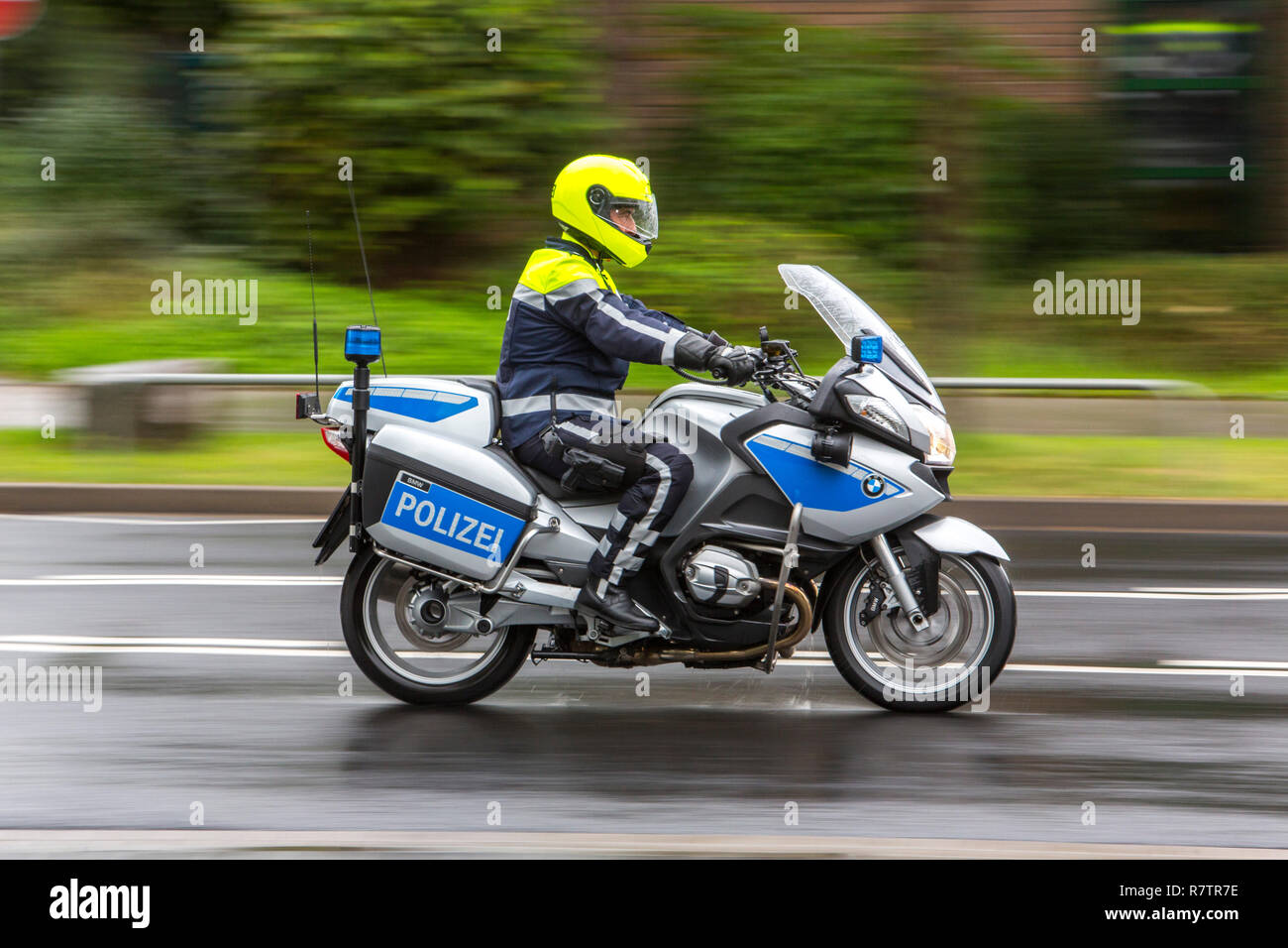 Policeman wearing a yellow helmet on a motorcycle, police motorcycle ...