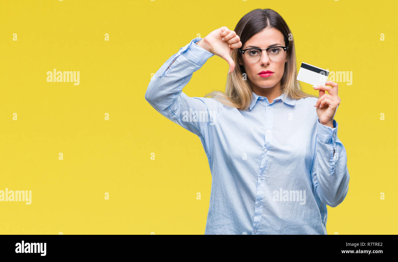 Young beautiful business woman holding credit card over isolated ...
