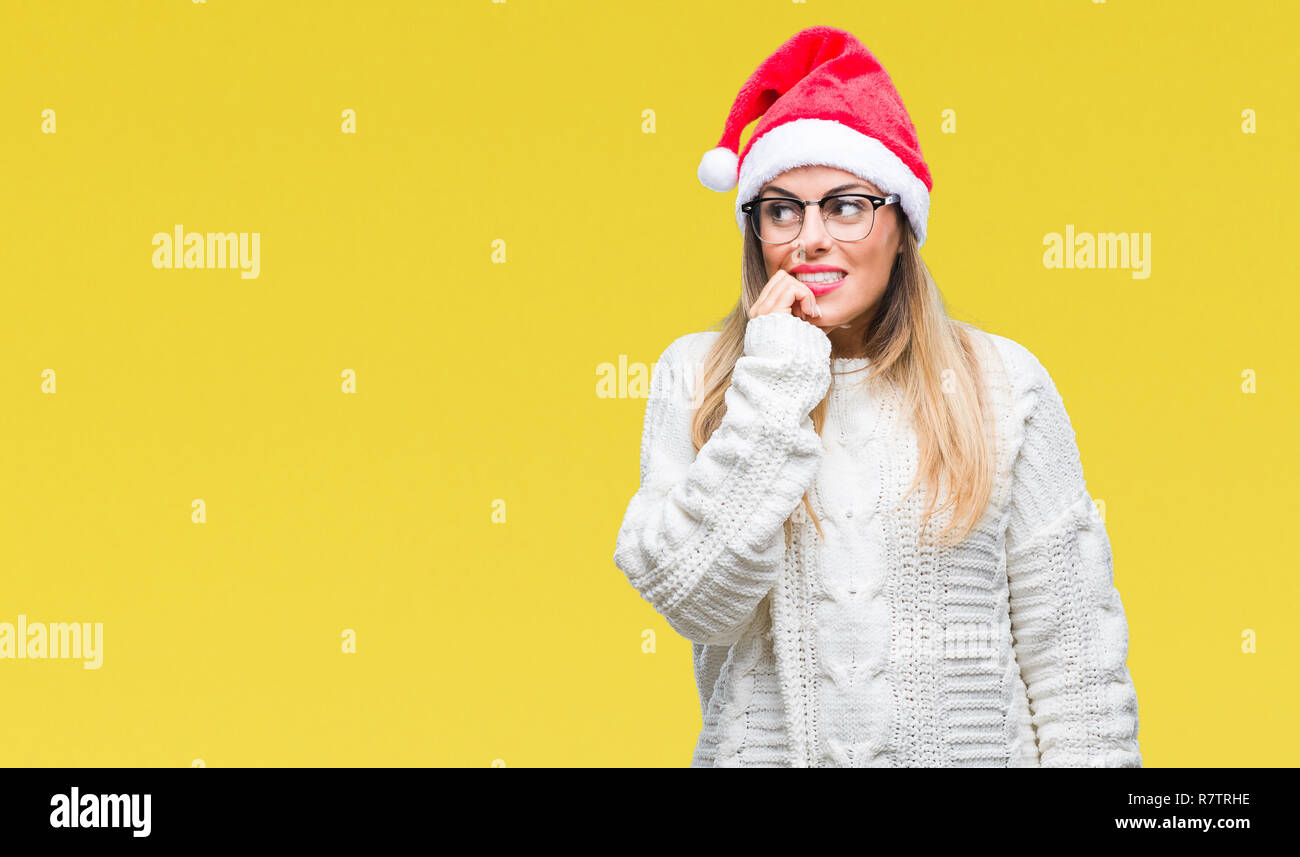 Young beautiful woman wearing christmas hat over isolated background ...
