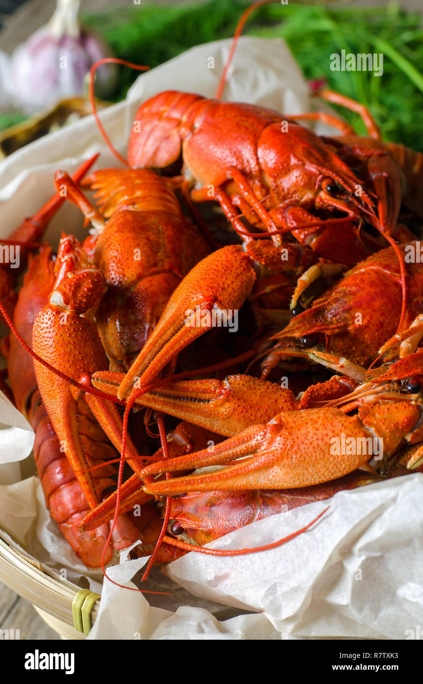 Boiled crawfish with dill in wooden dish Stock Photo - Alamy