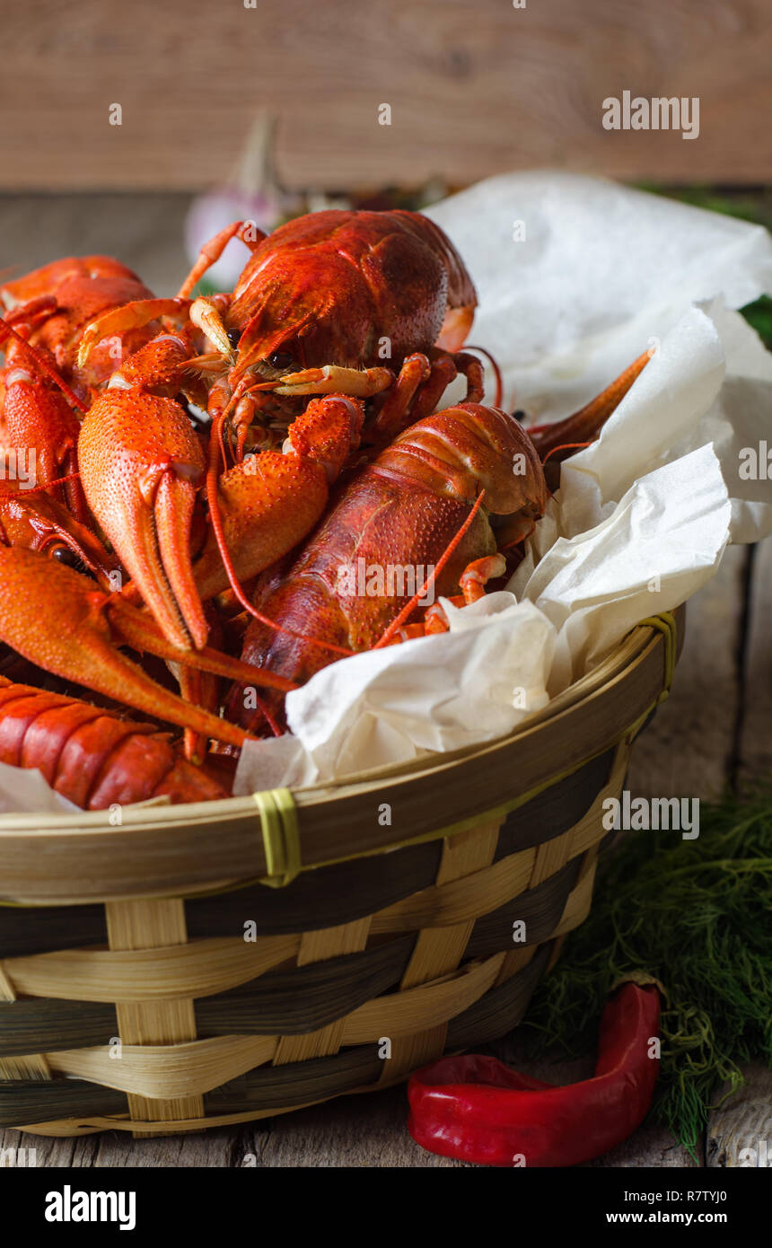 Boiled crawfish with dill in wooden dish Stock Photo - Alamy