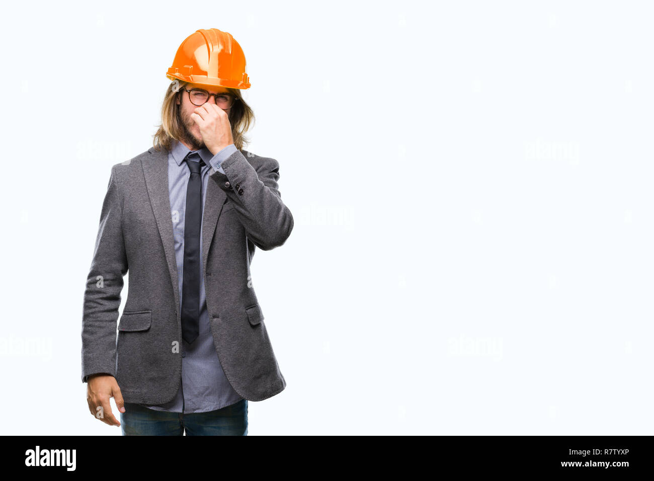 Young handsome architec man with long hair wearing safety helmet over ...