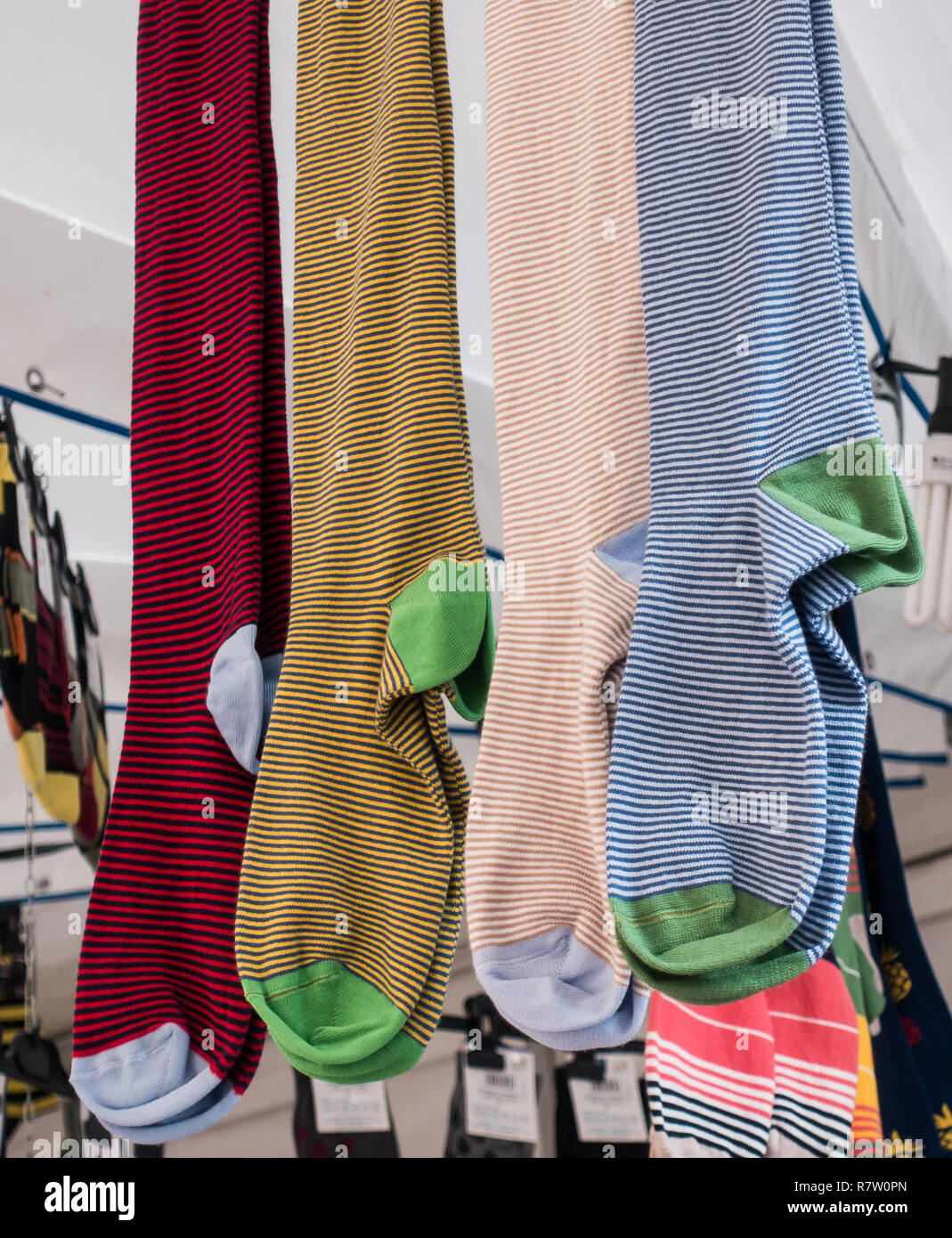 Cotton or wool socks hanging on display for sale Stock Photo - Alamy