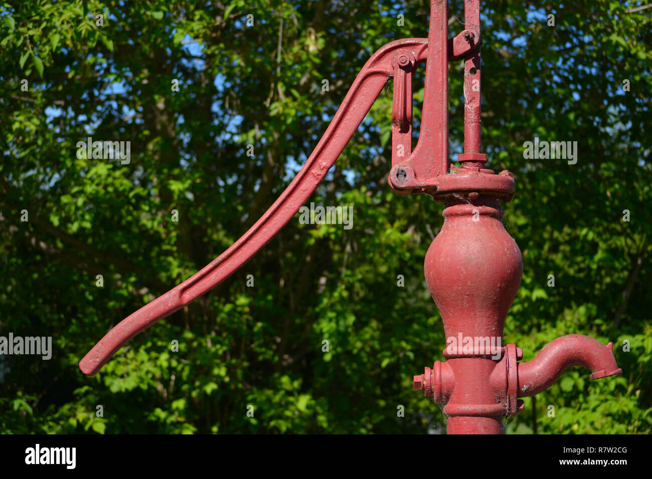 Hand water pump with farm yard shelter trees Stock Photo - Alamy