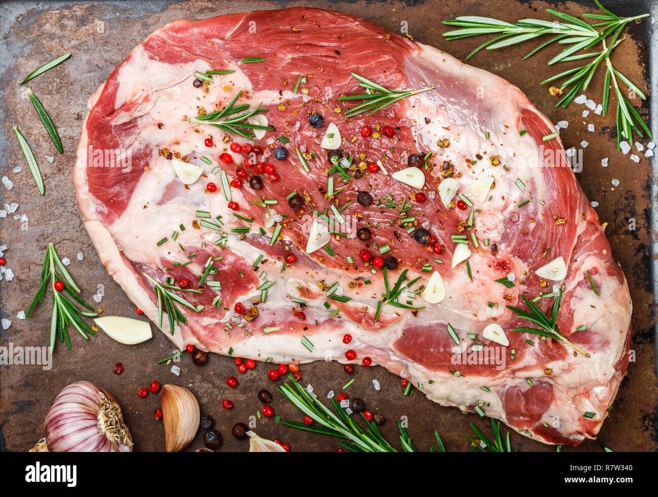 Fresh meat. Raw lamb shoulder ready for baking with garlic, rosemary ...