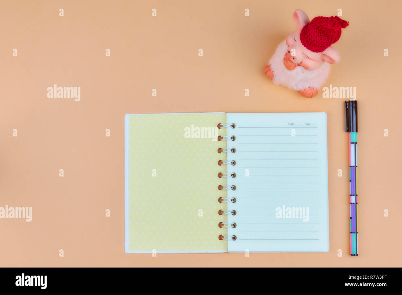 Office desktop New Year's pig, white fox, notebook, pen on the color of ...