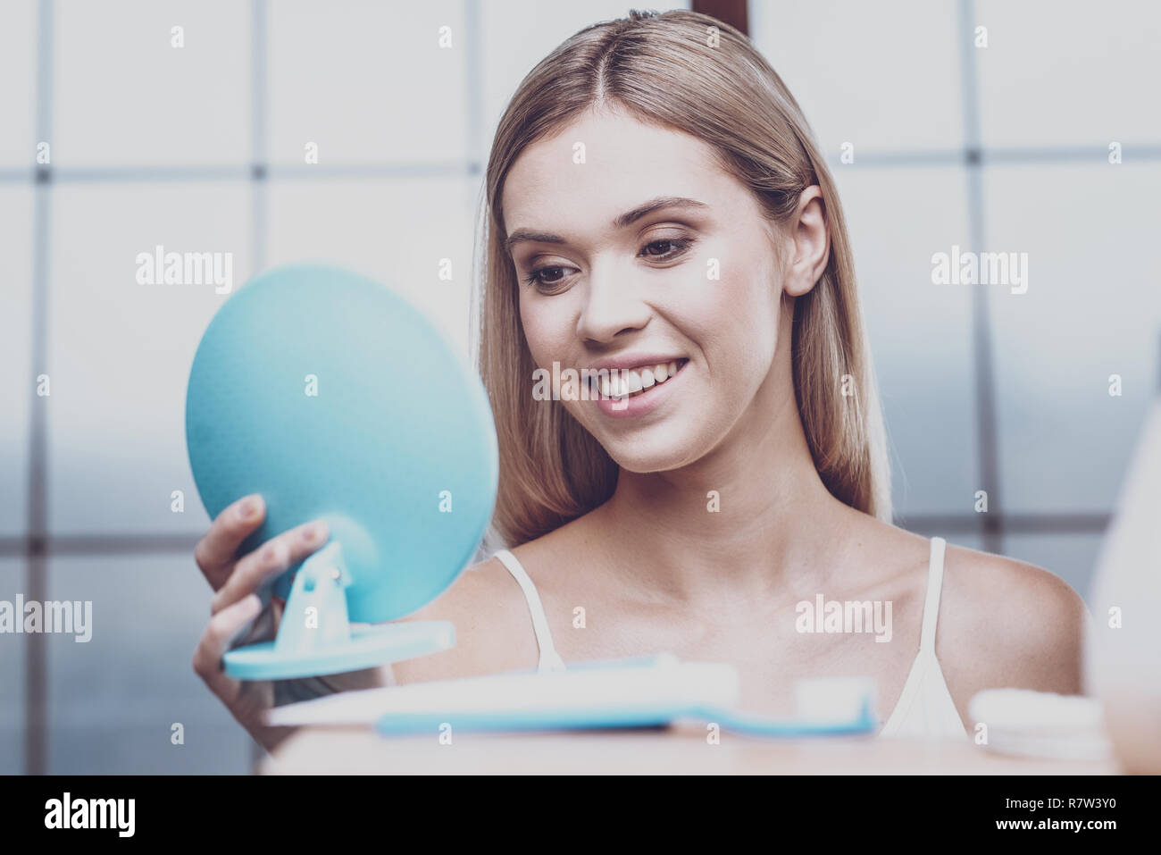 Young woman mirror face touch hi-res stock photography and images - Alamy