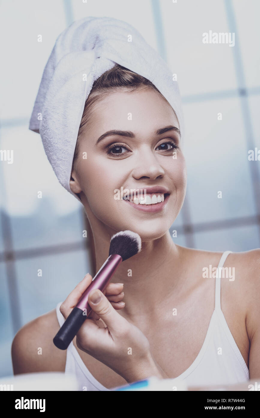Young woman powdering her face Stock Photo - Alamy