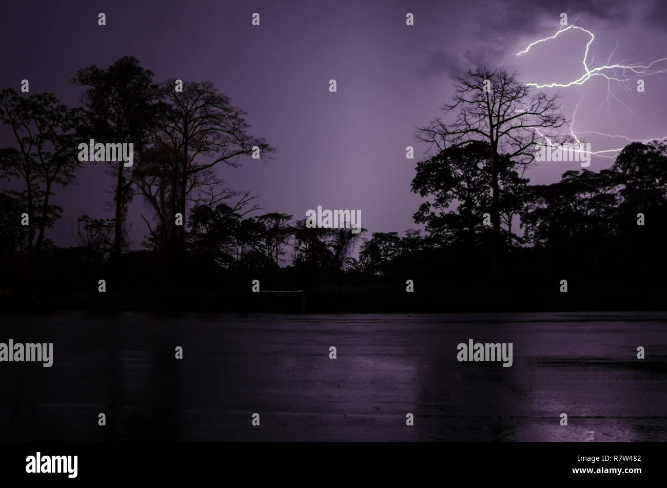 Lightning strikes during dramatic thunderstorm with silhouettes of ...