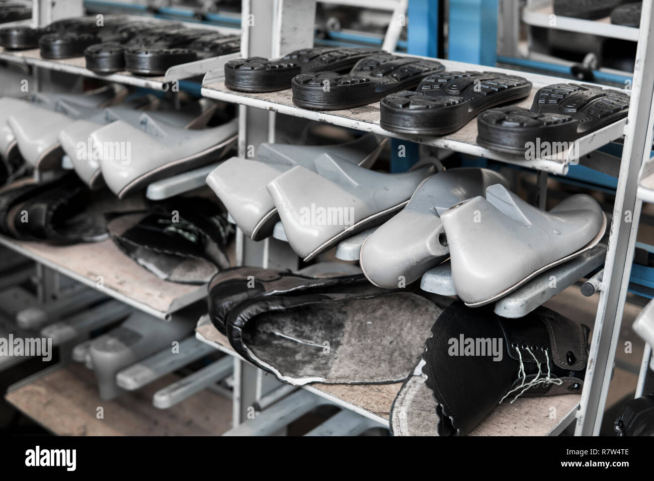 The conveyor on a shoes factory with shoe and sole. Mass production of ...