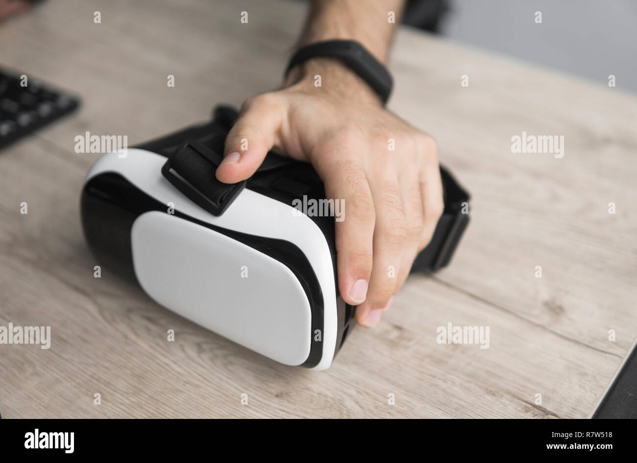 VR virtual reality glasses on a table with a man hand Stock Photo - Alamy