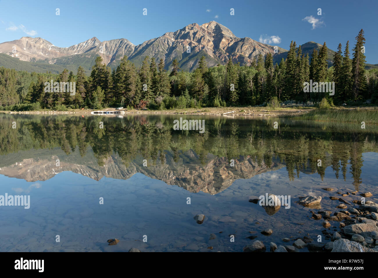 View of Pyramid Mountain and forest and their reflection in Edith lake ...
