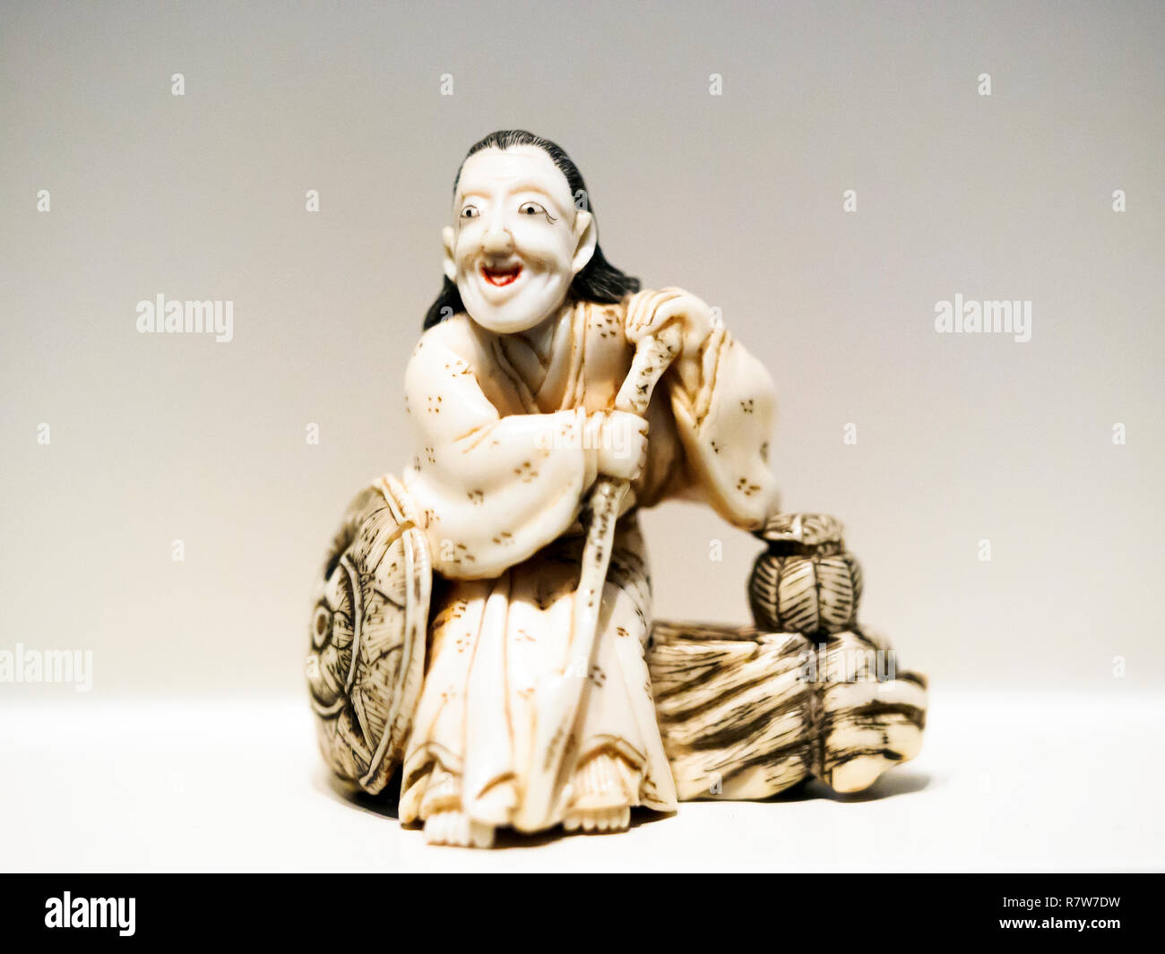 The female poet Ono no Komachi sitting on a log Netsuke figurine Stock ...