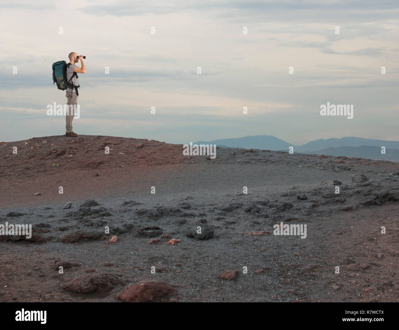 Explorer with binocular searches something in a desert Stock Photo - Alamy