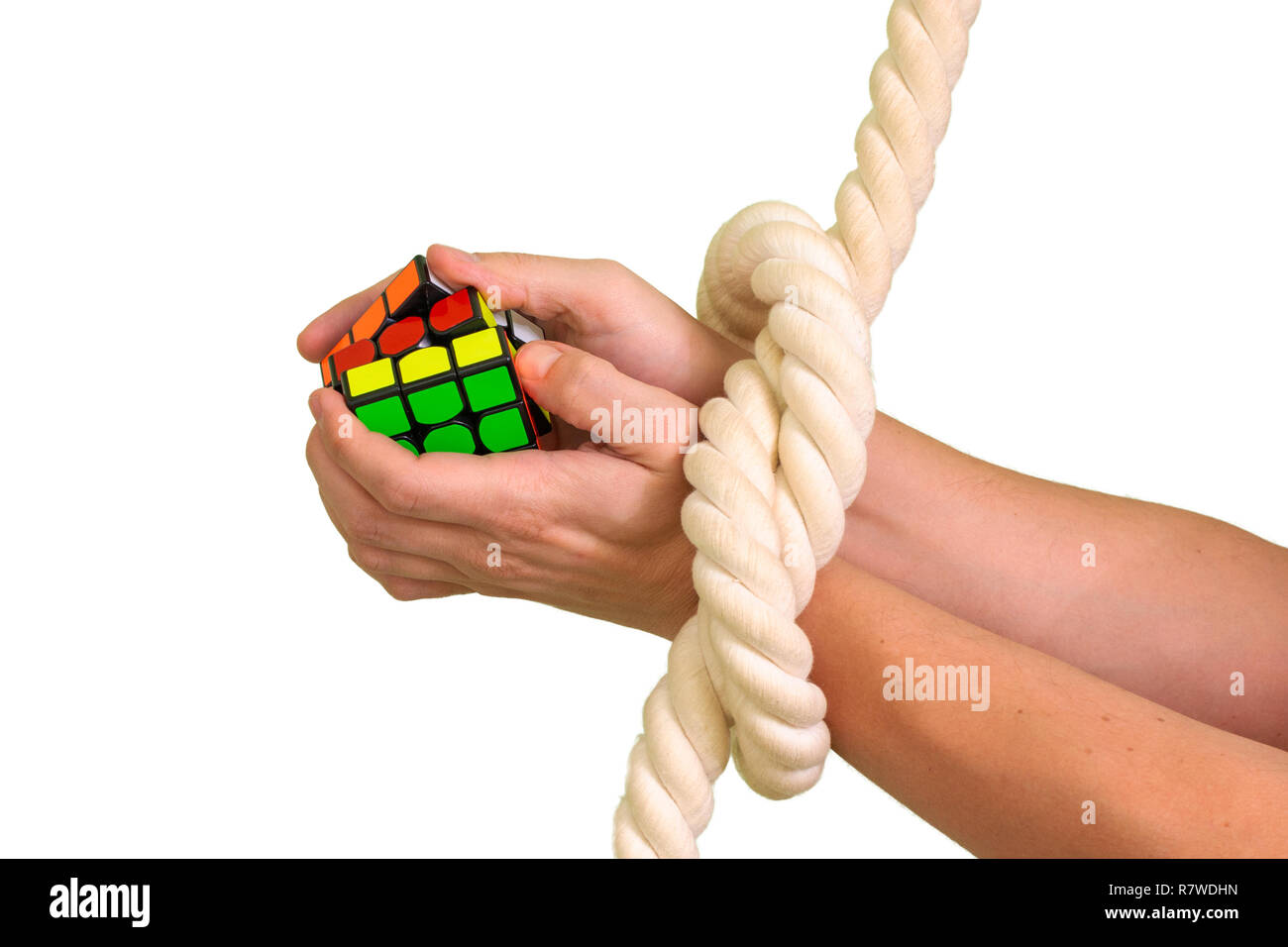 Cube puzzle with bandaged hands with a rope on a white background Stock ...